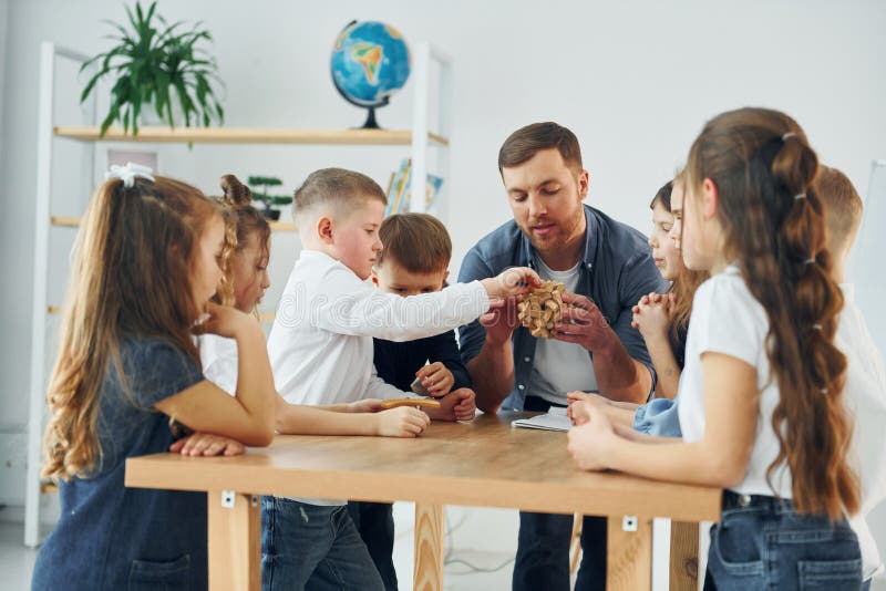 Exploring Puzzle Toy. Group of Children Students in Class at School ...