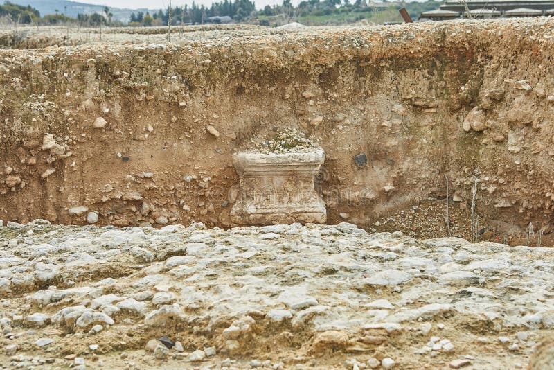 An Exposed Ancient Ruin Wall with a Partially Buried Column Base ...
