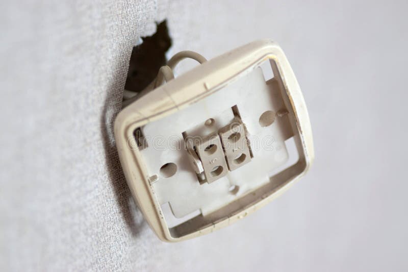 Exposed Electrical Socket with Missing Cover on a White Wall Stock ...