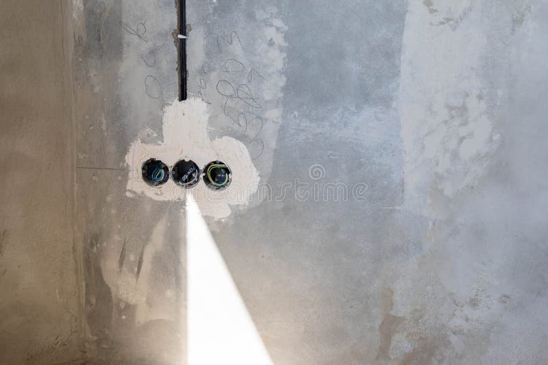 Exposed Electrical Sockets with Visible Wiring Mounted on a Wall in a ...