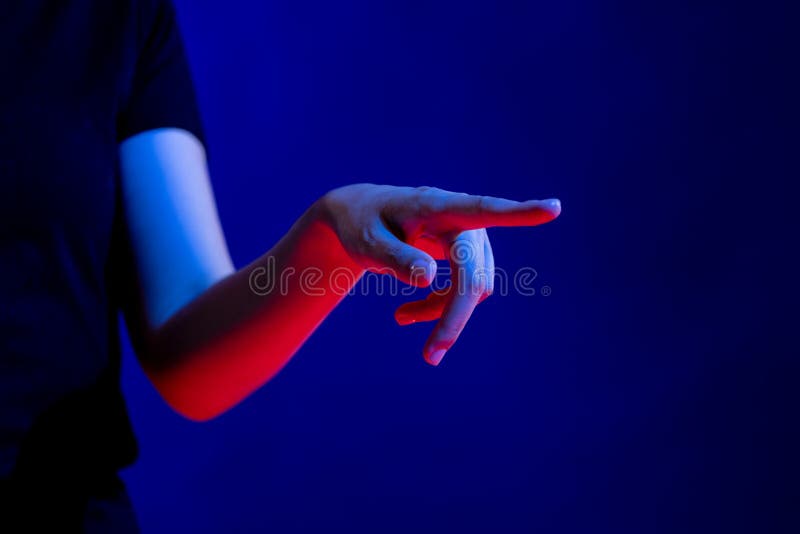 Exposed Hand Pointing Finger in Studio with Blue Light with Copy Space ...