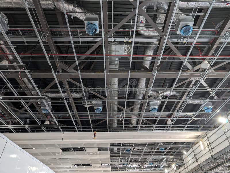 Exposed Industrial Ceiling with HVAC Ductwork and Suspended Grid System ...