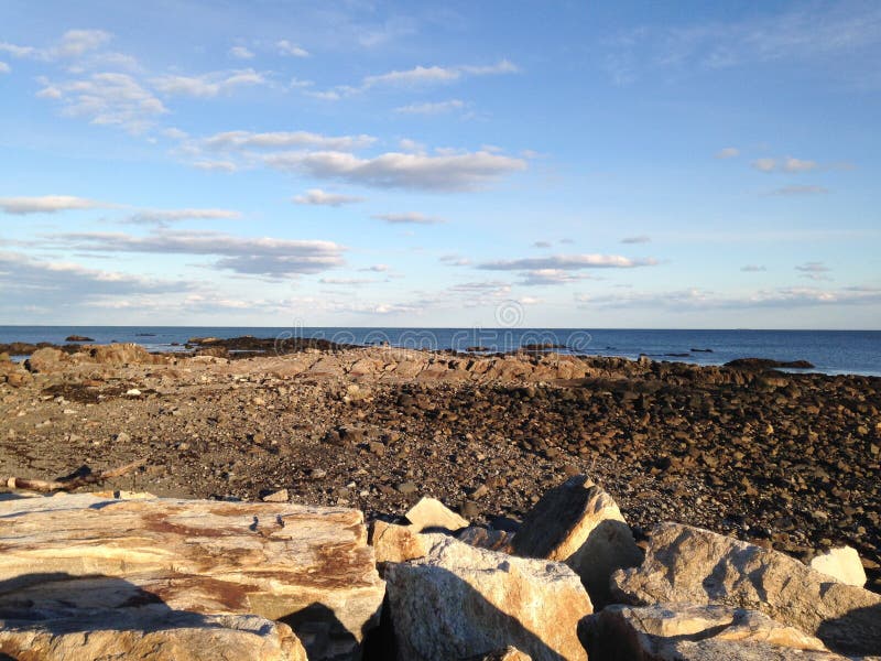 Rocks at low tide stock image. Image of shore, clouds - 112523011