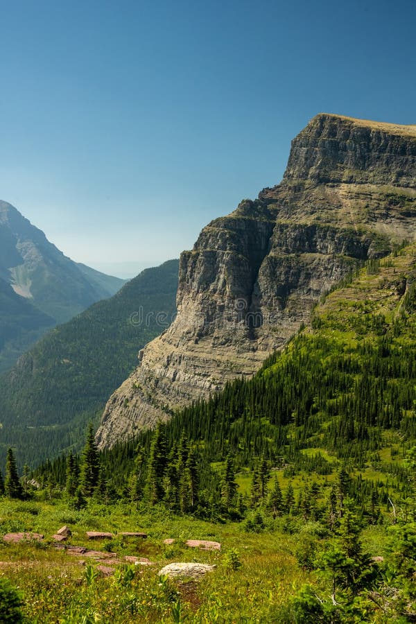 Exposed Wall of Boulder Pass Rises Over the Thick Forest Below Stock ...