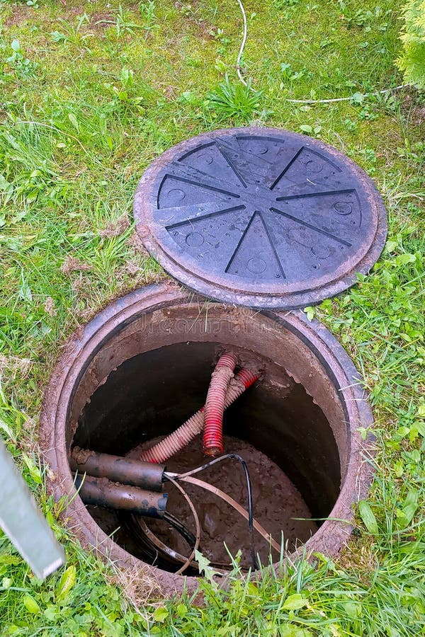 Exposed Well Cables and Maintenance Access in a Grassy Area during ...