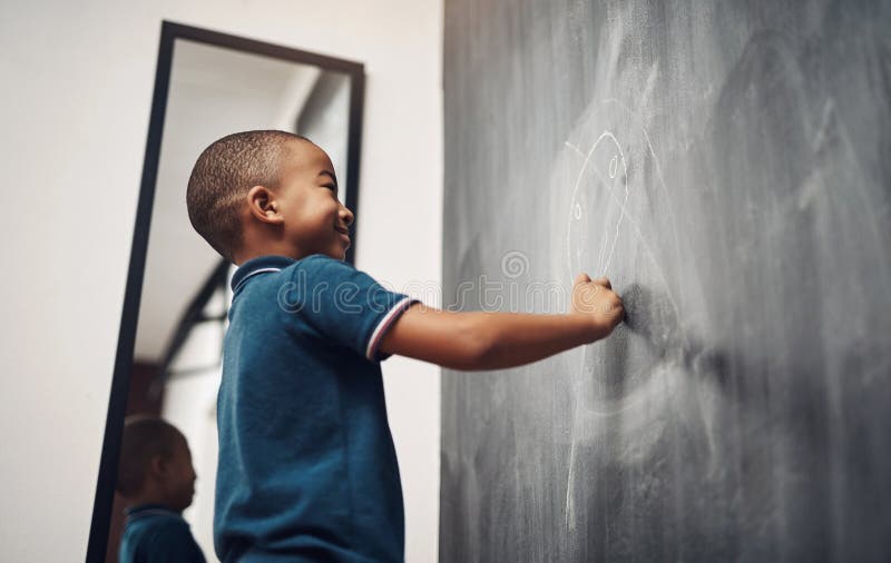 We Express Ourselves through Visual Art. a Young Boy Writing on a ...