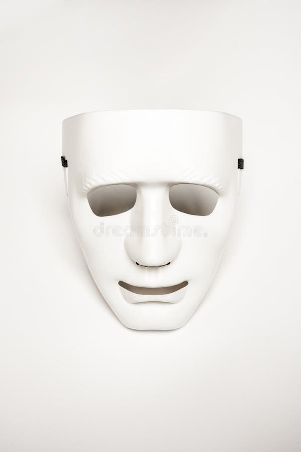 An Expressionless White Masquerade Mask Lying on a Smooth White Surface ...