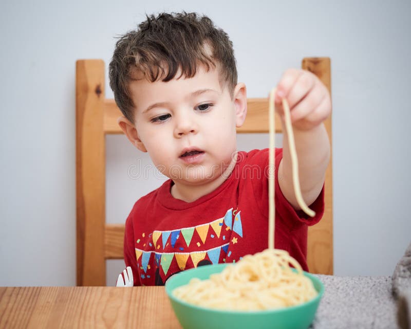 Expressive Boy is Playing with His Food at Lunch Stock Photo - Image of ...