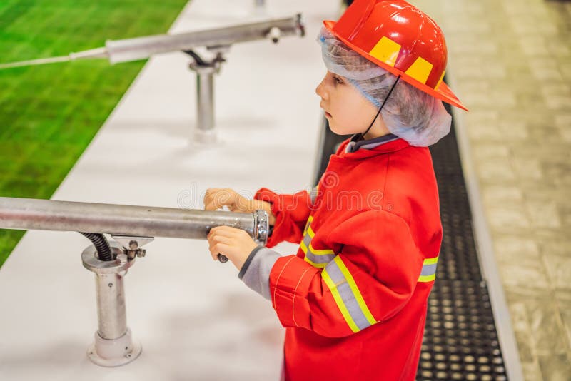 Expressive Cute Toddler with Fireman Outfit Playing Fireman Stock Photo ...
