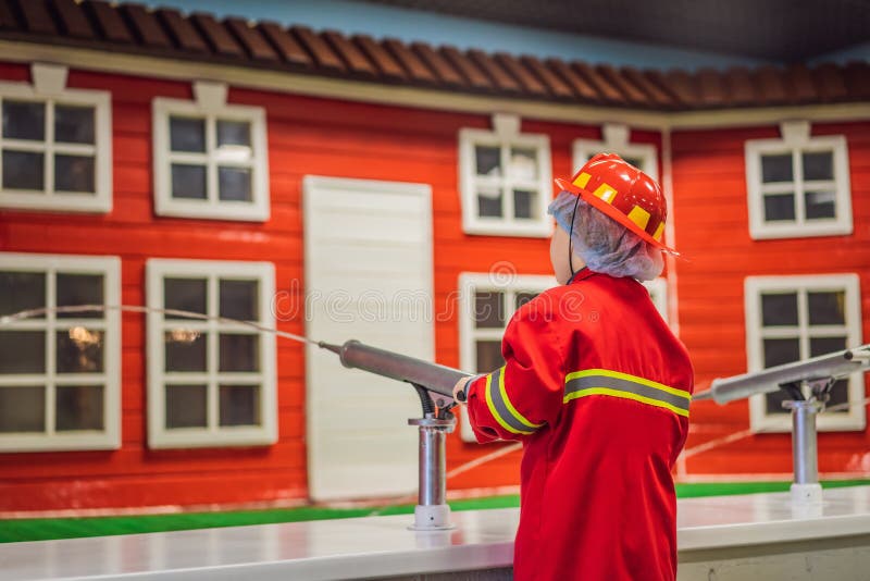Expressive Cute Toddler with Fireman Outfit Playing Fireman Stock Photo ...