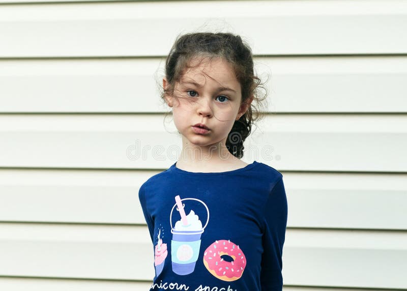 Expressive Young Girl Posing and Making Faces in the Backyard Stock ...