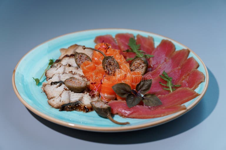 Exquisite Assorted Sashimi Platter on Elegant Blue Ceramic Plate Stock ...