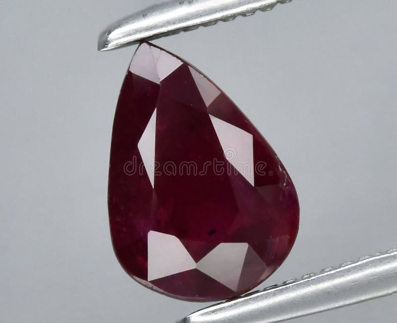 Exquisite Deep Red Pear-Shaped Ruby Gemstone Captured in Reflective ...