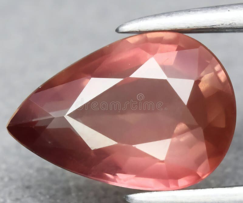 Exquisite Pear-Shaped Pink Gemstone Captured in Gleaming Silver Setting ...