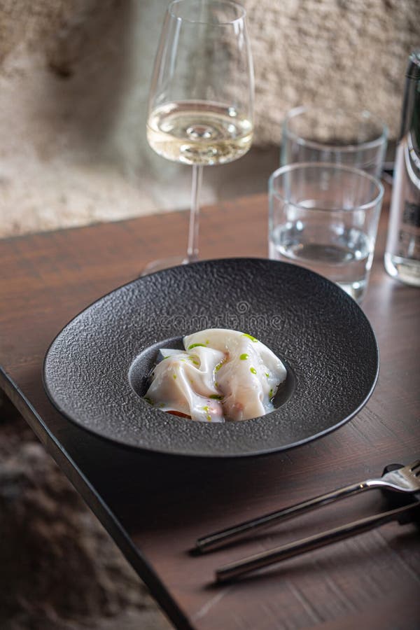 Exquisite Seafood Dish Presentation with Wine and Elegant Table Setting ...