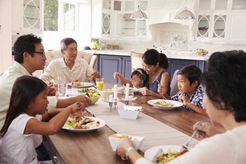 Extended Family Group Eating Meal at Home Together Stock Image - Image ...