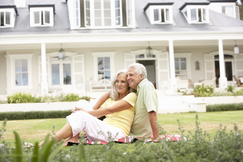 Extended Family Group Sitting Outside House on Lawn Stock Photo - Image ...