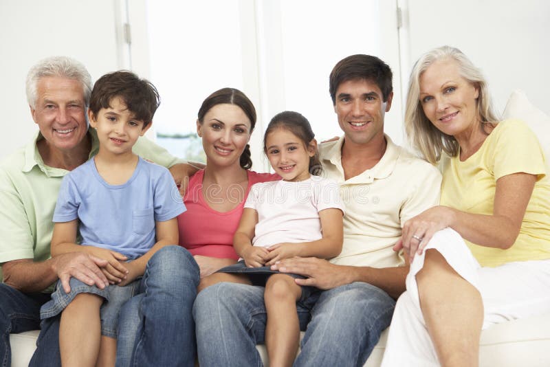 Extended Family Relaxing on Sofa at Home Together Stock Photo - Image ...