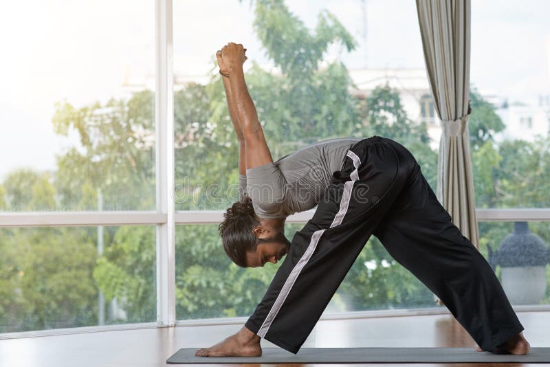 Extending triangle pose stock photo. Image of flexible - 97345622
