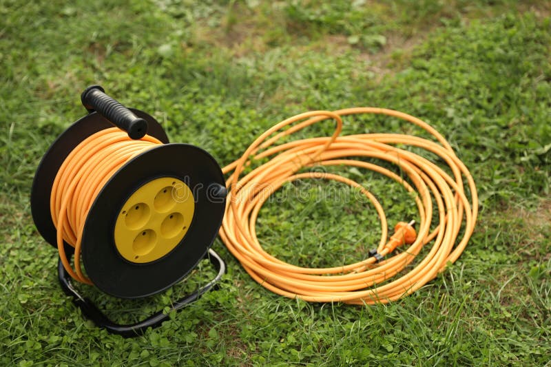 Extension Cord Reel on Green Grass Outdoors Stock Photo - Image of reel ...