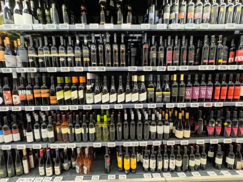 Extensive Wine Selection on Supermarket Shelf Featuring Diverse Bottles ...
