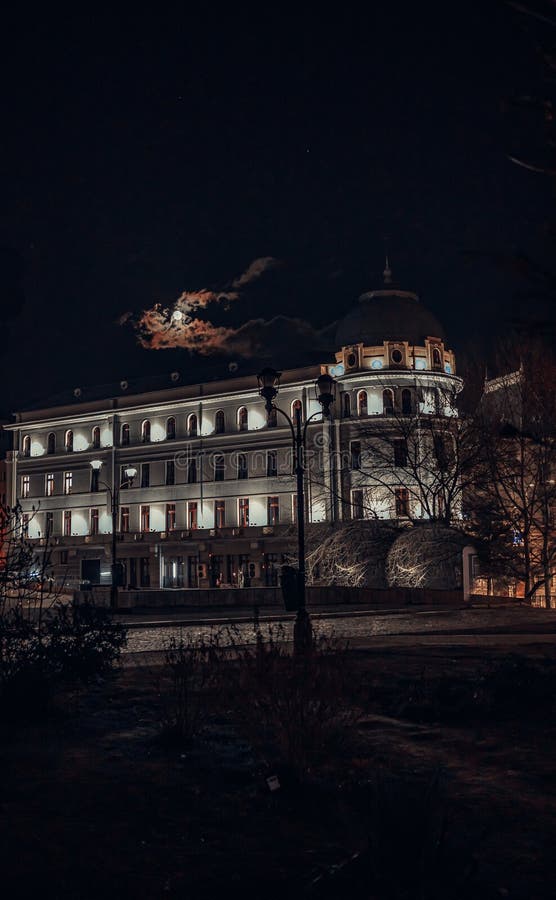 The Exterior of a Dark Building with Lots of Windows at Night Stock ...
