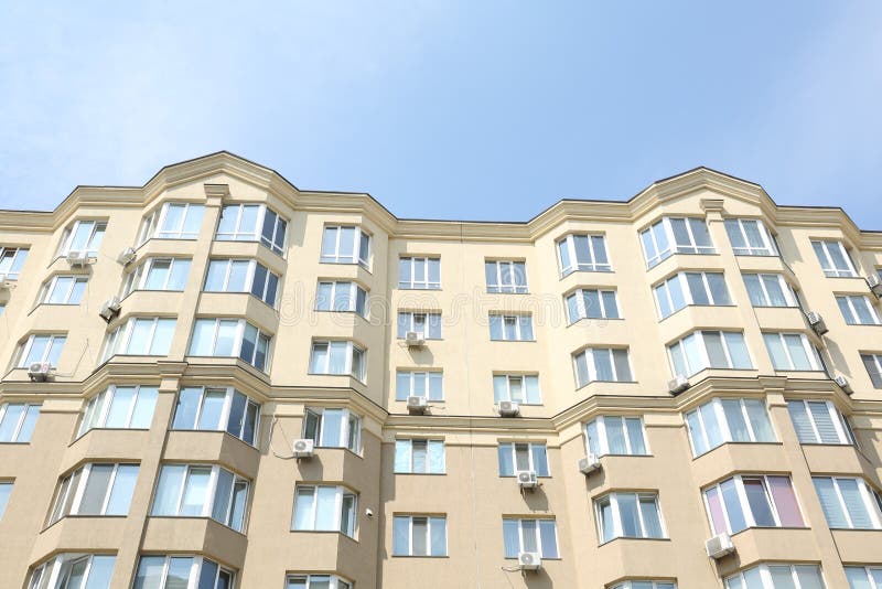 Exterior of Multi Storey Apartment Building Against Blue Sky, Low Angle ...