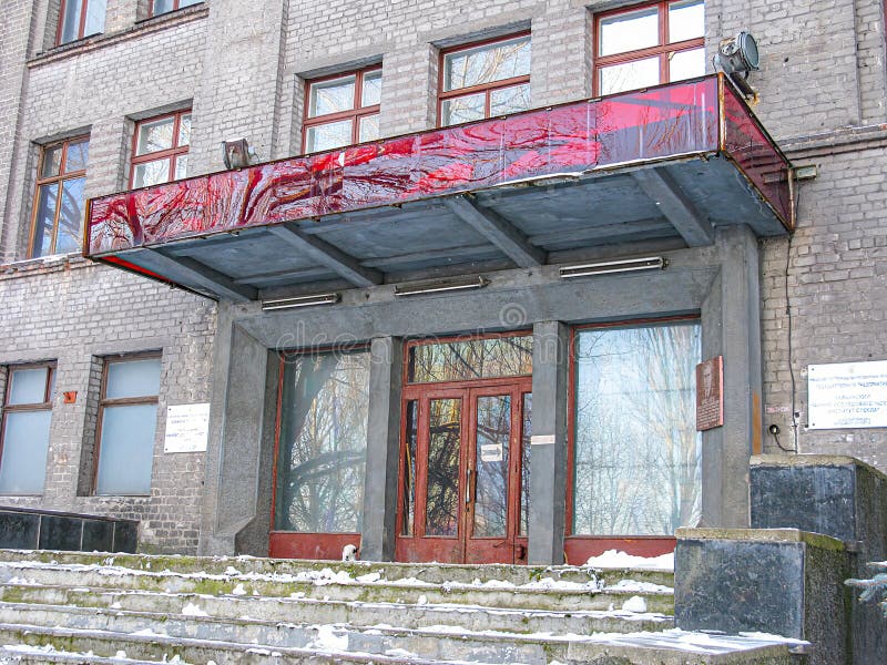 Exterior View of a Brick Building with Double Doors, Windows, Balcony ...