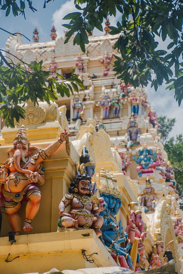 Three Statues are on the Side of a Building with Many Other Sculptures ...