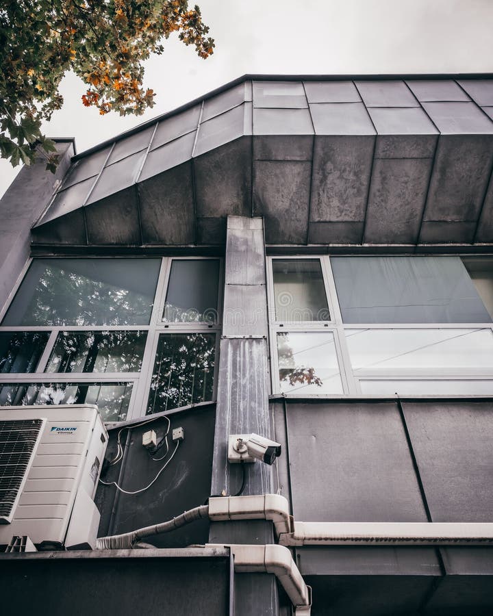 The Exterior View of a Modern Building with Many Windows and a Small ...