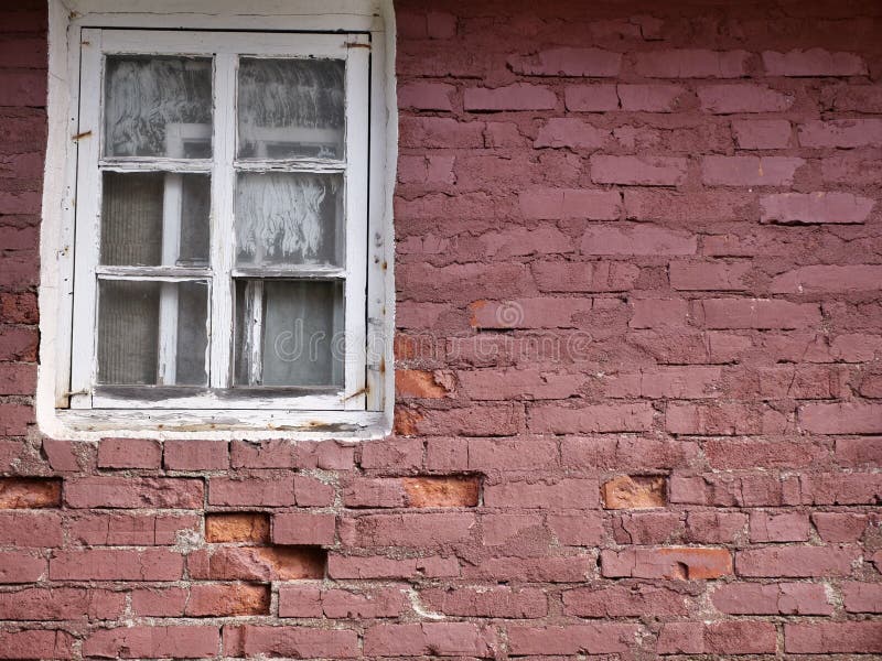 Exterior View of an Old Building with a White Window and Red Bricks in ...