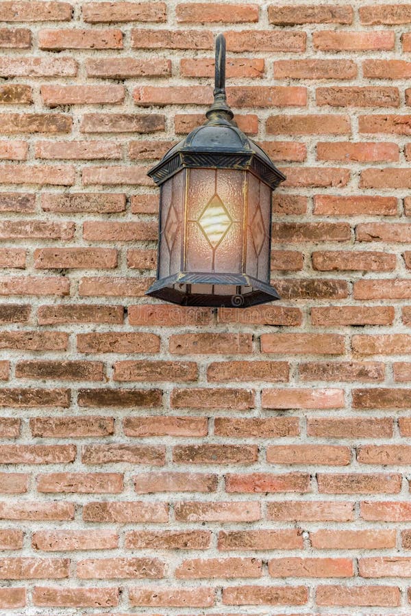 Exterior Vintage Wall Lamp Illuminated on Brick Wall Building. Stock ...
