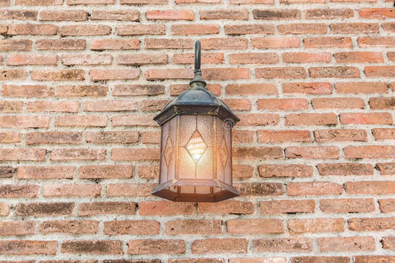 Exterior Vintage Wall Lamp Illuminated on Brick Wall Building. Stock ...