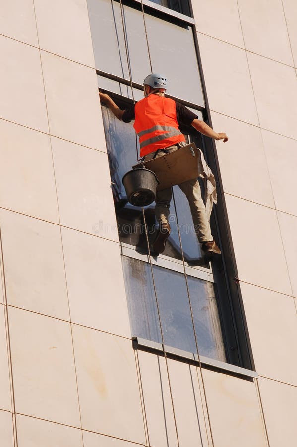 High Rise Window Cleaning Worker Cleans an Office Building Stock Photo ...