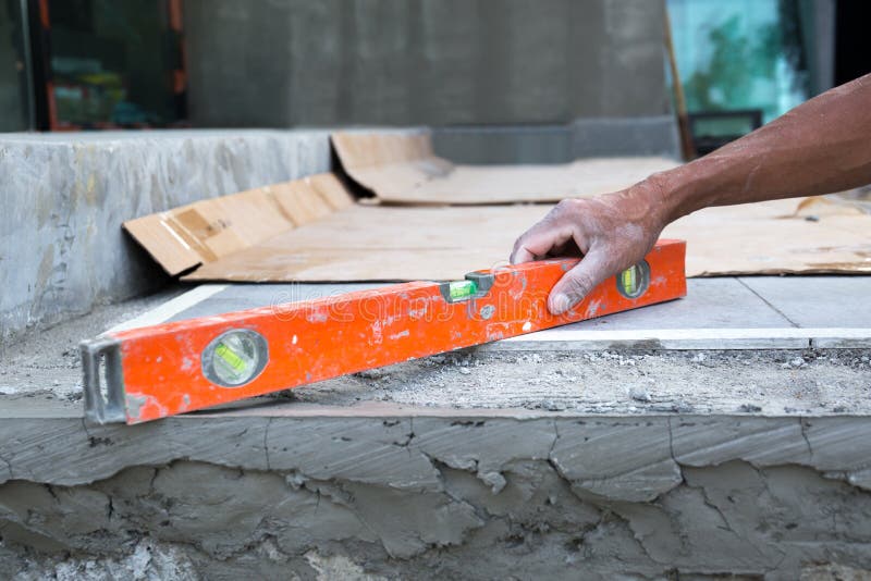 Exterior Worker Using Level for Laying Cement Floor Stock Image - Image ...