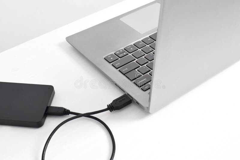 External Backup Hard Disk Drive Connected To Laptop on White Background ...