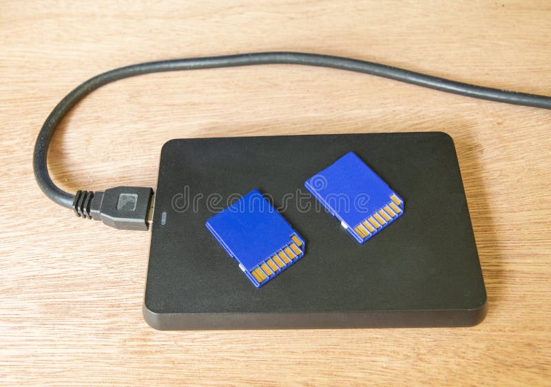 External Computer Disk and Two Camera Memory Cards on a Desk Stock ...
