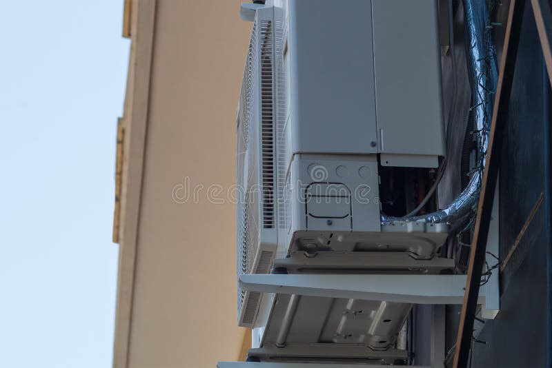 External Heat Pump Unit Against the Wall of the House. Modern ...