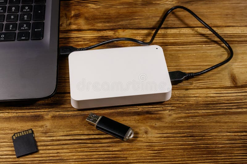 External HDD Connected To Laptop Computer on Wooden Desk. Concept of ...