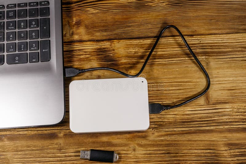 External HDD Connected To Laptop Computer and USB Flash Drive on Wooden ...