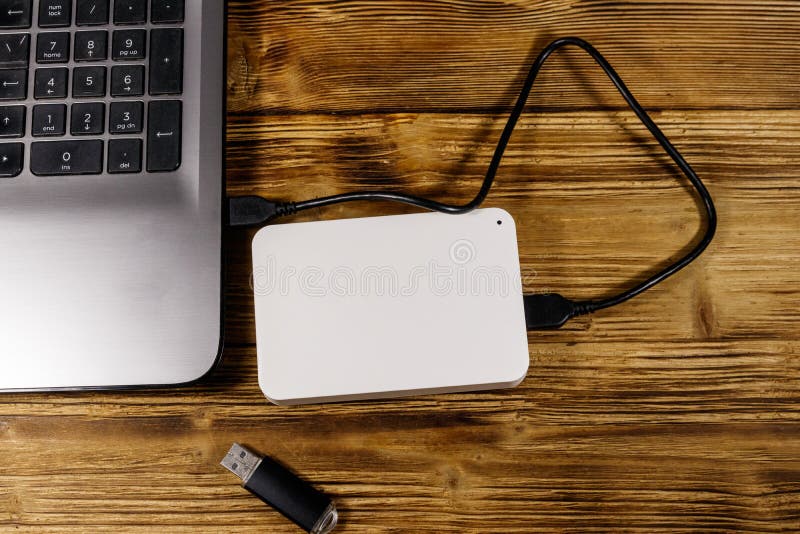 External HDD Connected To Laptop Computer and USB Flash Drive on Wooden ...