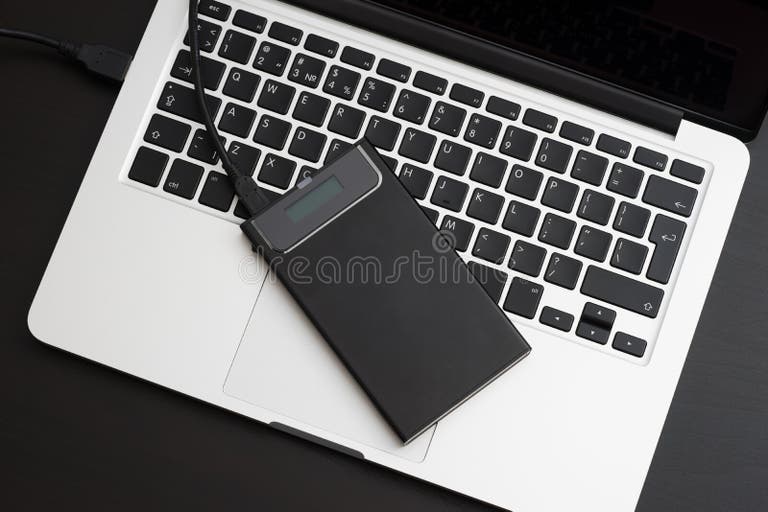 External HDD over laptop stock image. Image of cable - 76158095