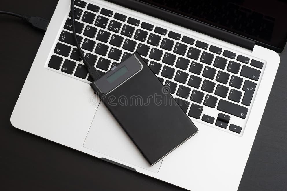 External HDD over laptop stock image. Image of cable - 76158095