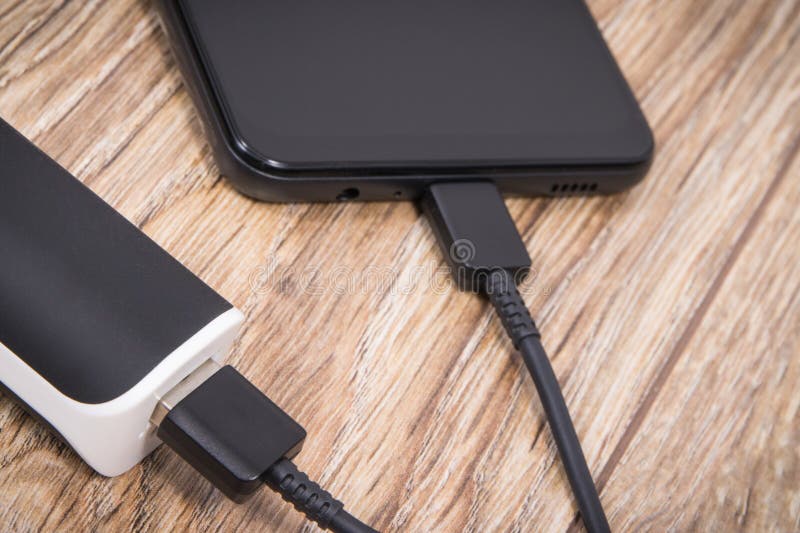 External Powerbank Using To Charge Empty Battery of Black Smartphone ...