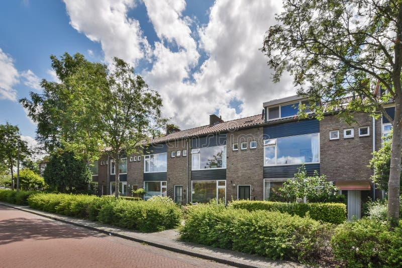 External View of a Brick Building with Trees and Bushes Editorial Image ...