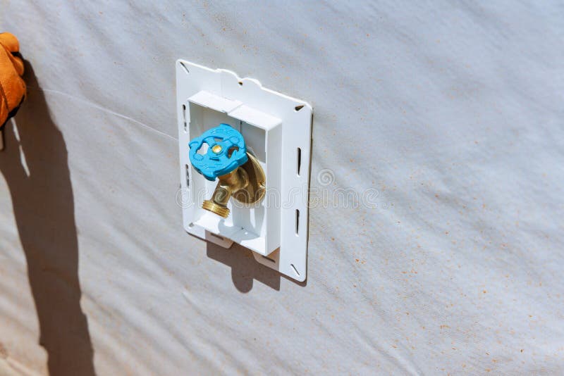 An External Water Tap is Installed on Facade of House by a Plumber ...