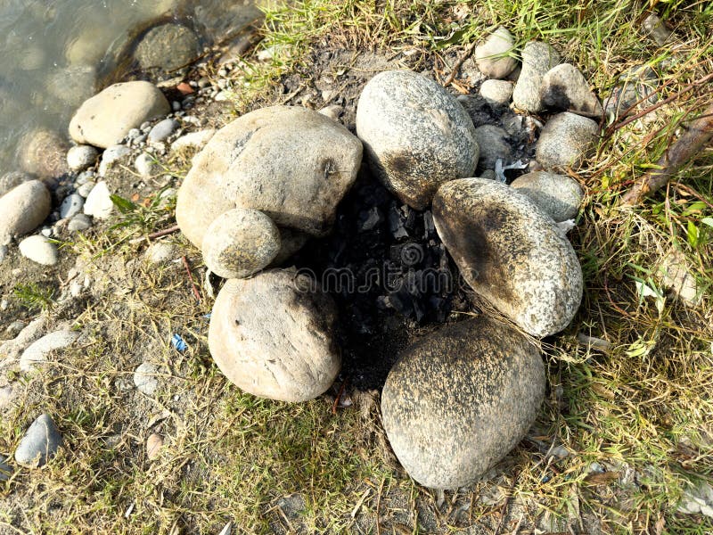 Extinguished Campfire Circle with Burnt Stones by the Riverside Stock ...