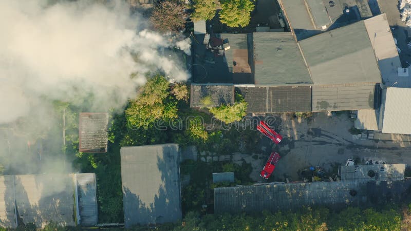 Extinguishing a Fire in a Warehouse by a Fire Brigade. Smoke from the ...
