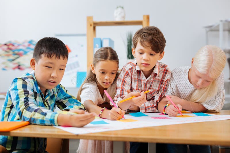 Concentrated Kids Drawing a Bright Poster in a Class Stock Photo ...