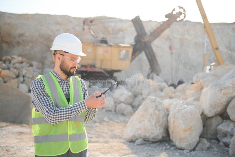 Extraction of Stone. Male Worker Next To Stone Quarry Stock Photo ...